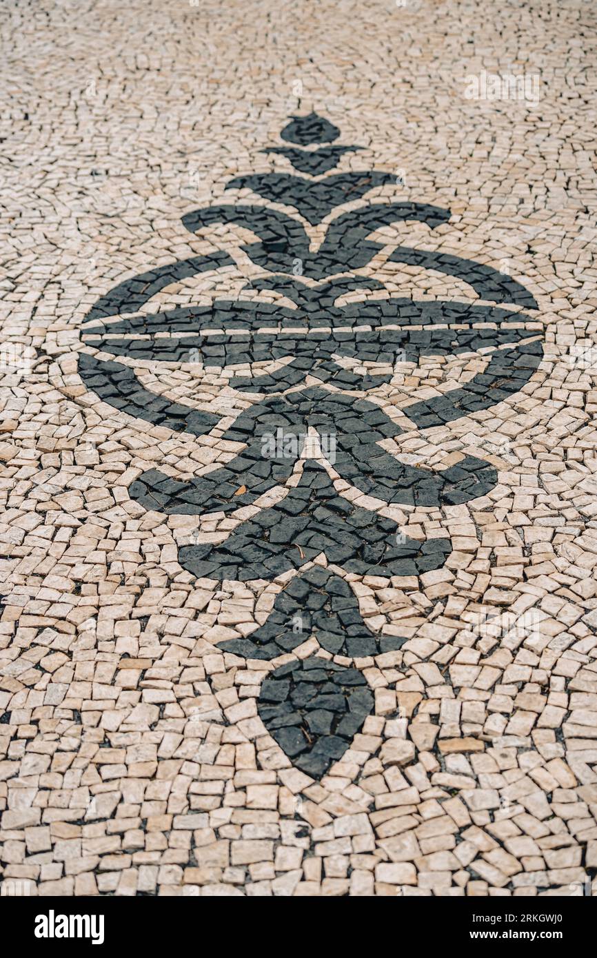 A cobblestone sidewalk featuring a black and white checkered pattern ...