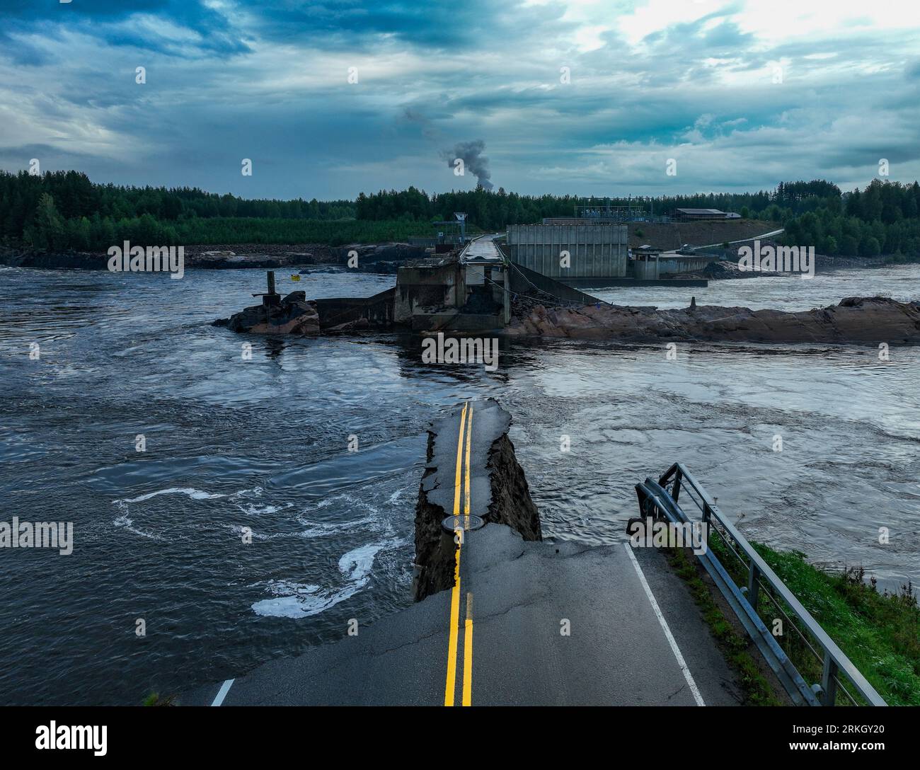 Aerial view of a destroyed bridge, its crumbled remains spread across a ...