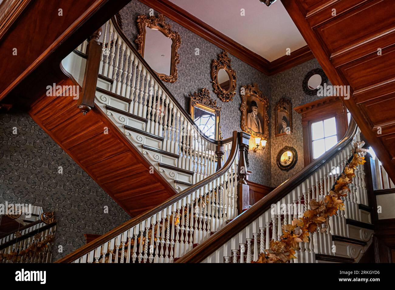 An empty stairwell inside an expansive room decorated with floral wall ...