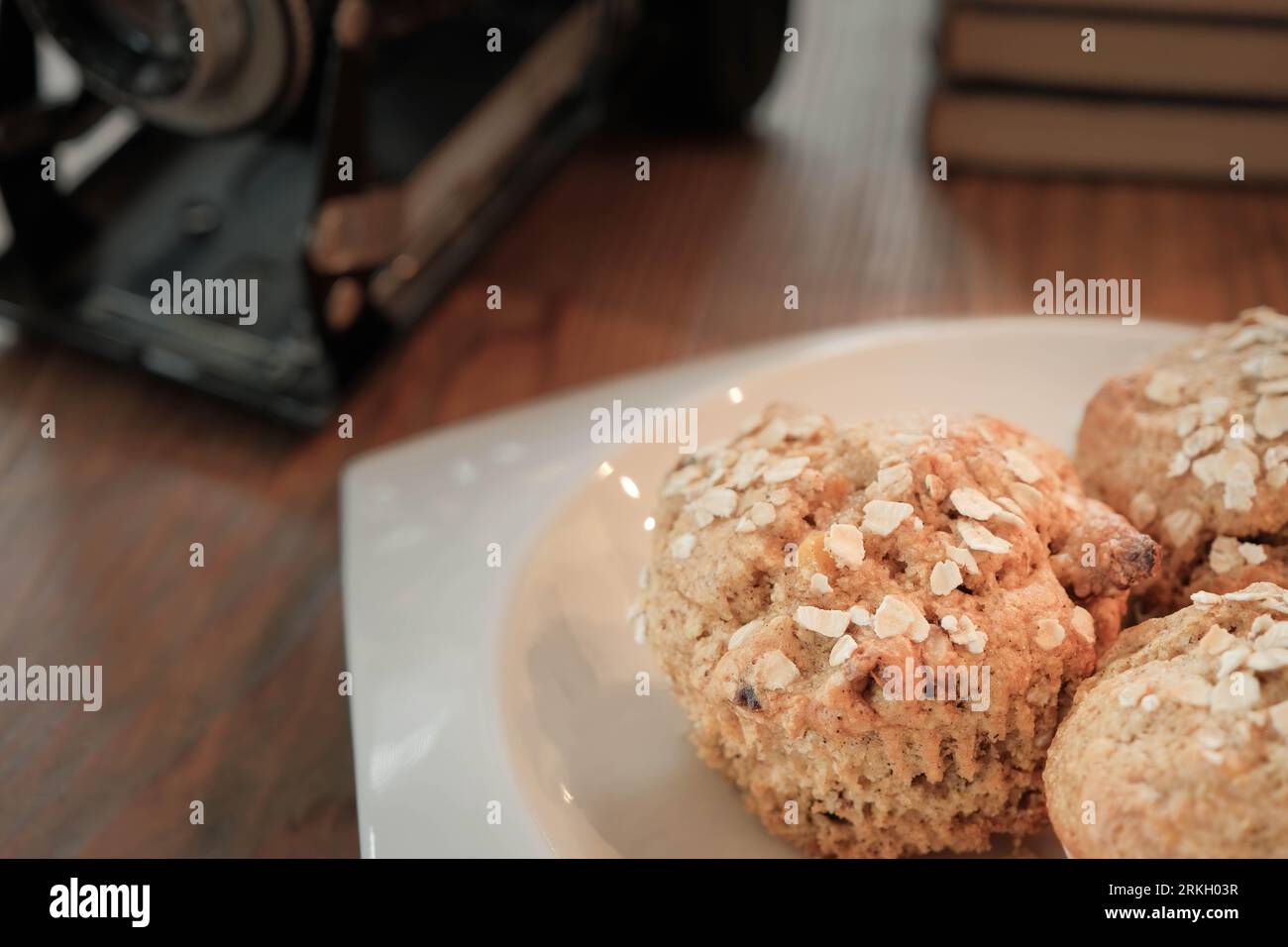 Rustic homemade muffins with retro camera and stack of books Stock ...