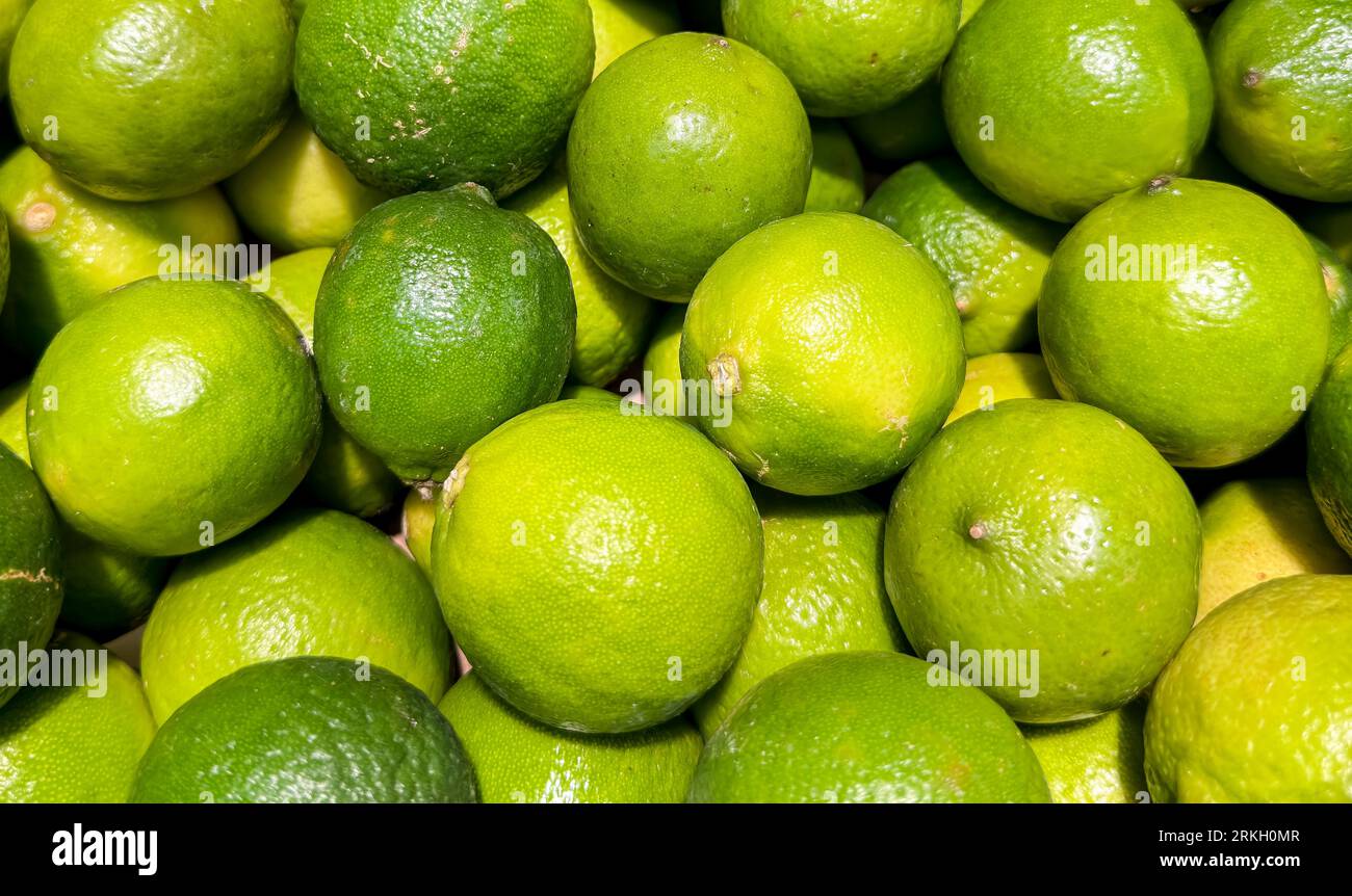 Limes. Green and ripe limes theme. Limes background Stock Photo - Alamy