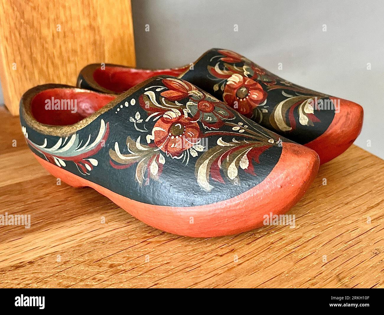 This stock photo features a pair of wooden clogs with a vibrant floral ...