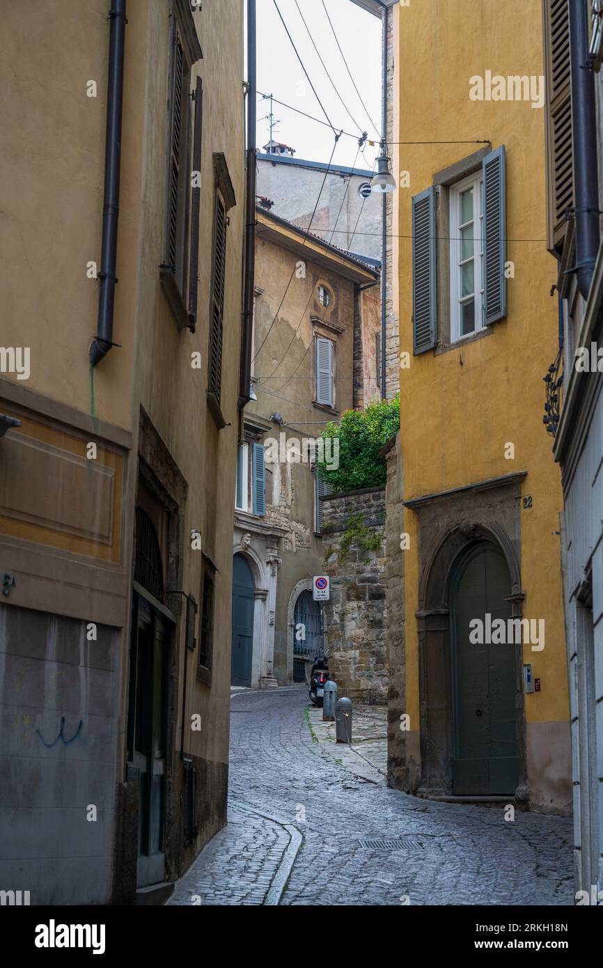 A vertical of colorful buildings between the narrow streets of Bergamo ...