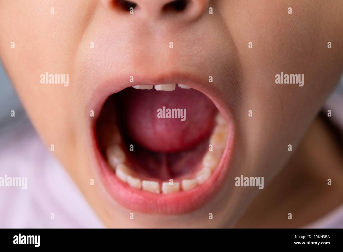 Headshot cropped image of cute preschool girl smiling wide showing milk ...