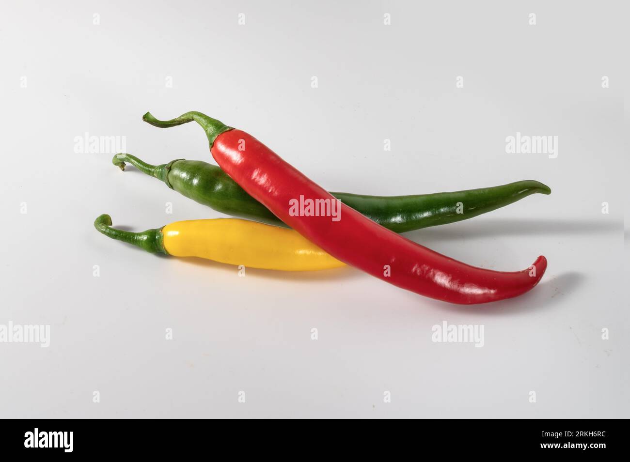 Chili peppers in 3 colours on white isolated Stock Photo - Alamy