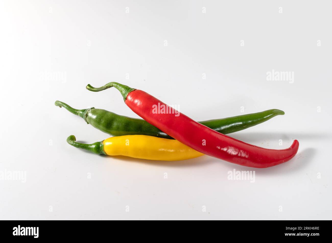 Chili peppers in 3 colours on white isolated Stock Photo - Alamy