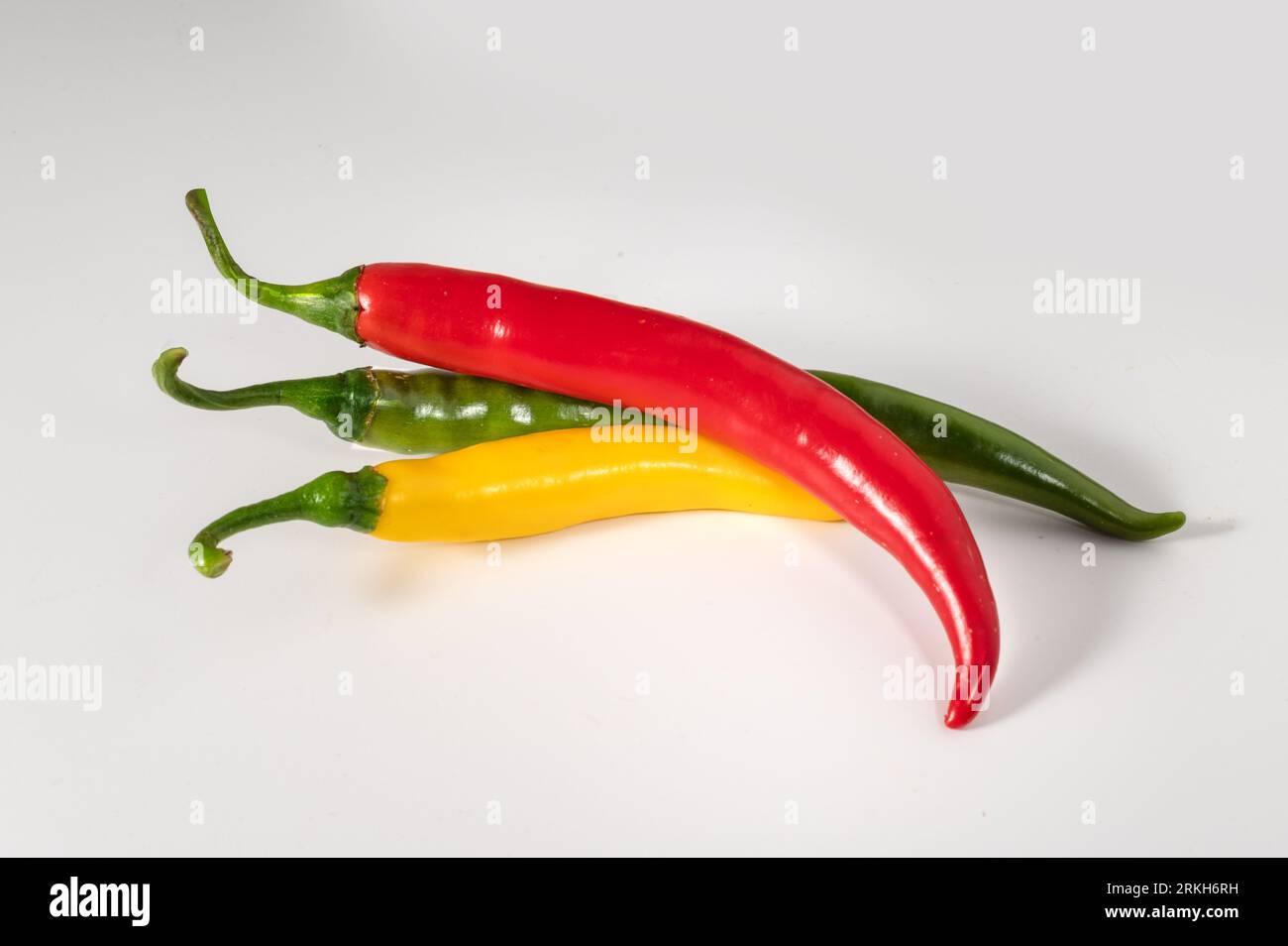 Chili peppers in 3 colours on white isolated Stock Photo - Alamy