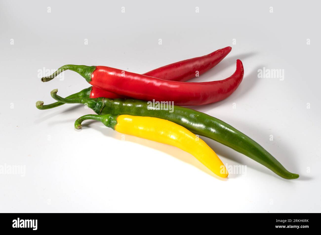 Chili peppers in 3 colours on white isolated Stock Photo - Alamy