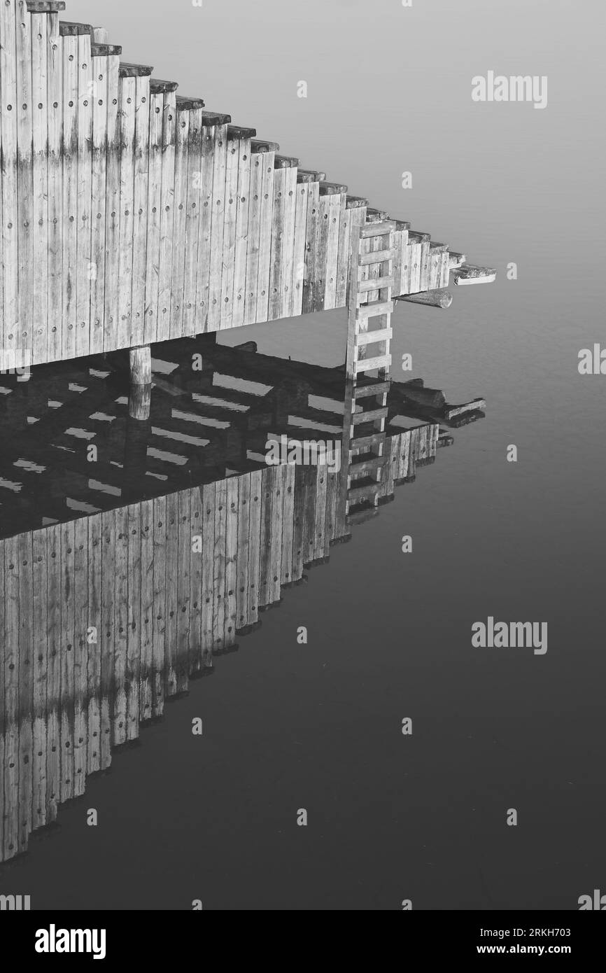 A wooden pier of Lake Mjosa in the town of Kapp, Norway, under a cloudy ...