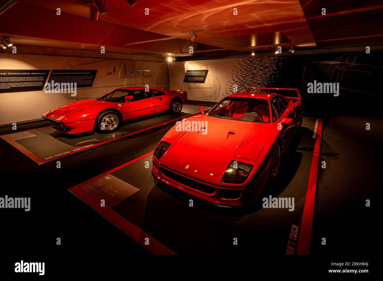 The two red Ferrari cars parked in a showroom in Italy Stock Photo - Alamy