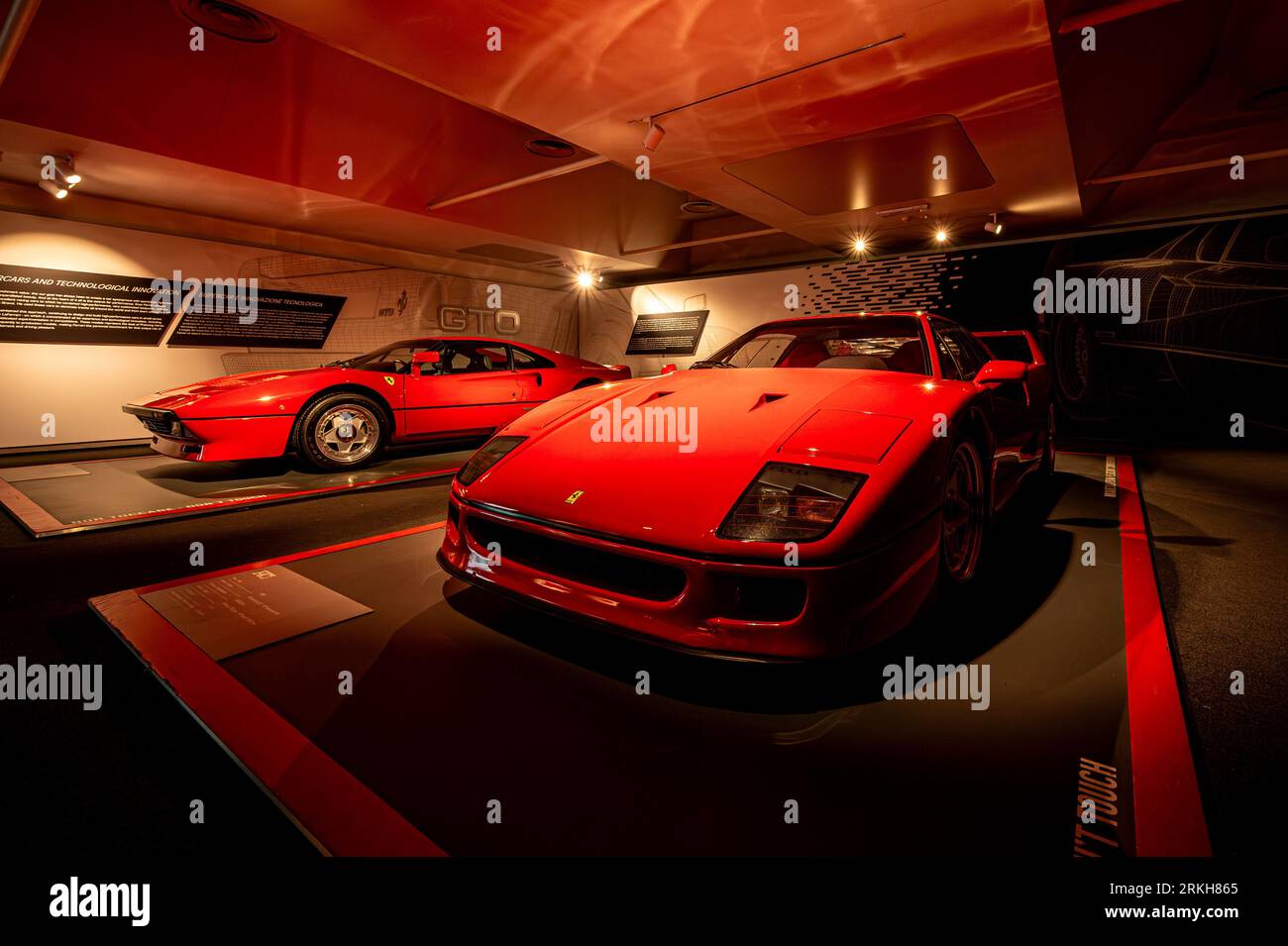 The two red Ferrari cars parked in a showroom in Italy Stock Photo - Alamy