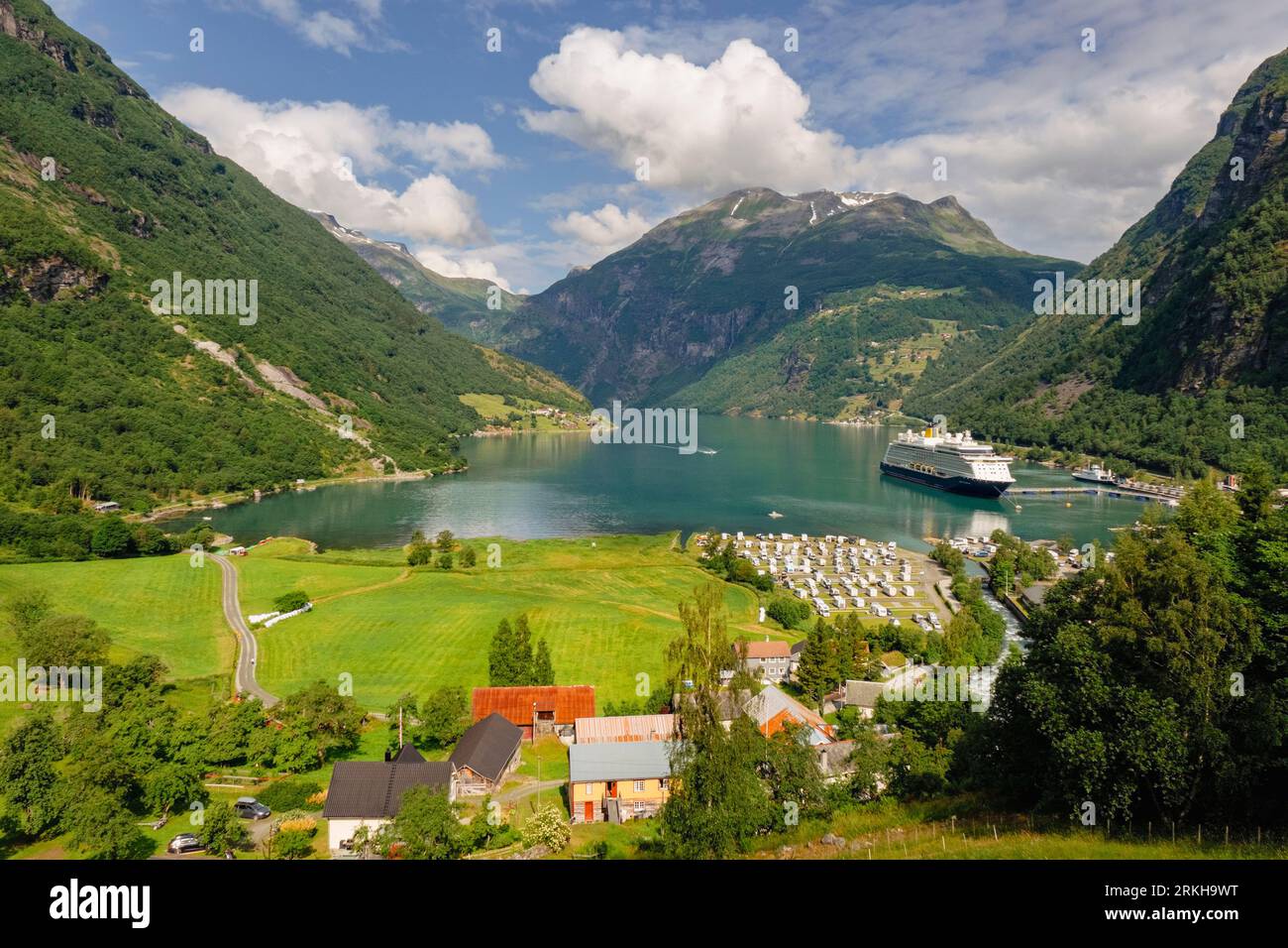 High view to Cruise ship moored in Geiranger Fjord with village ...