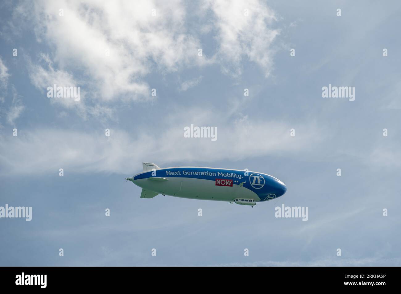 Mainau, Germany, July 20, 2023 Zeppelin is flying overhead the lake of ...