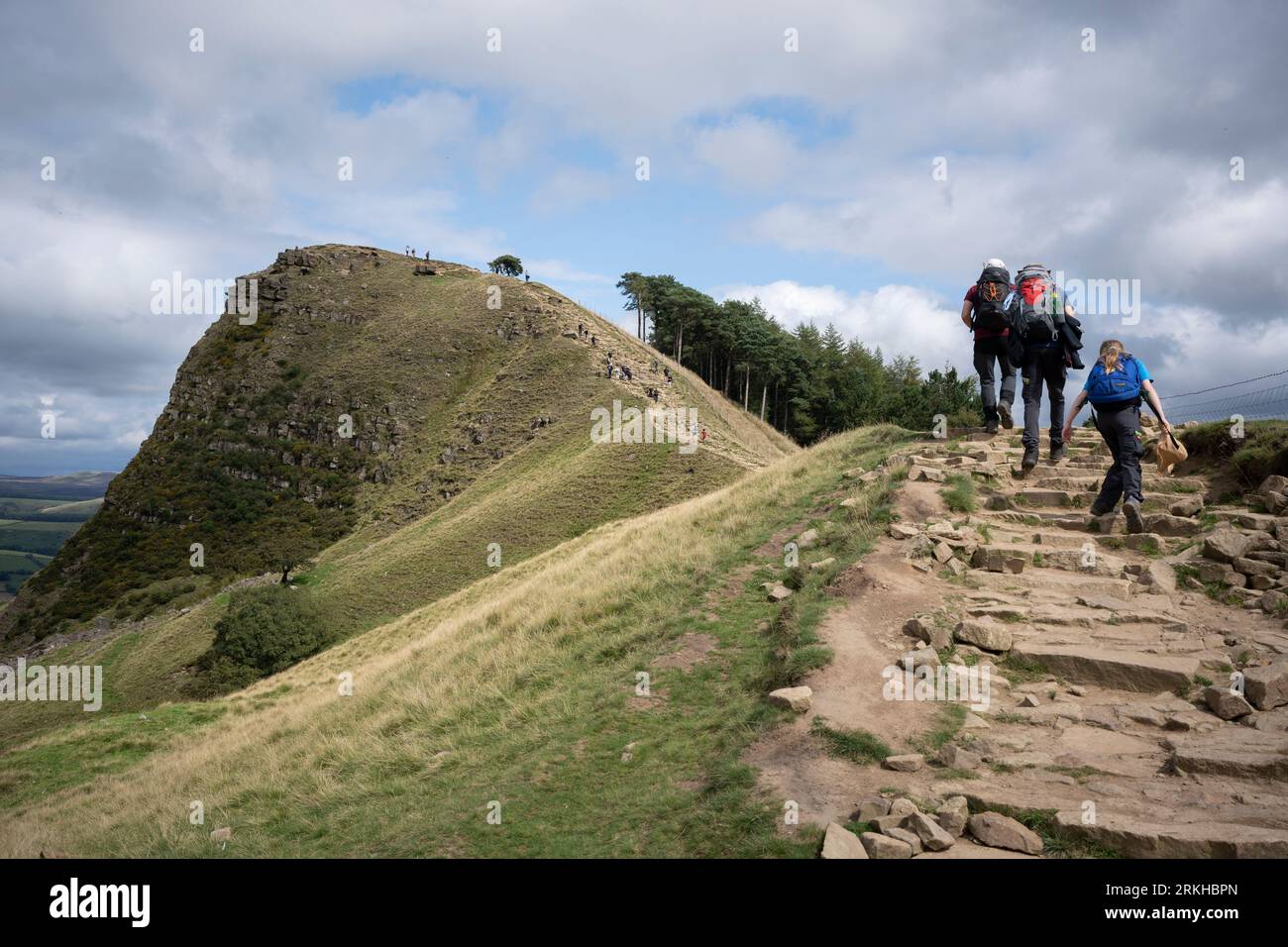 Family walkers and long-distance hikers climb the footpath along the ...