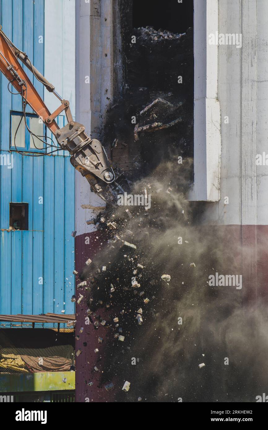 An orange construction excavator machine in operation on a demolition ...