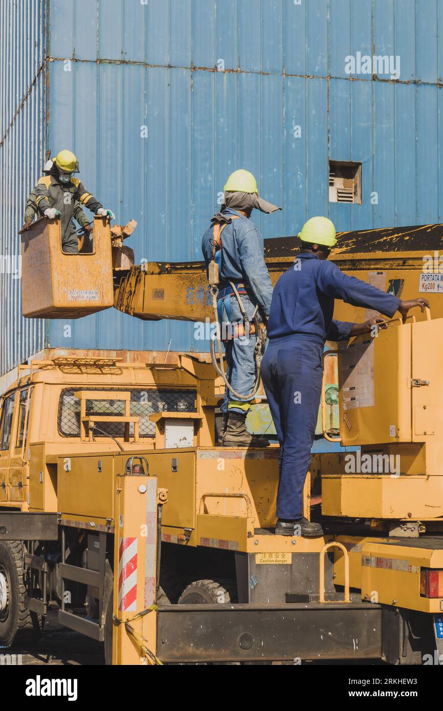 A rear view of two male workers working on a construction site Stock ...