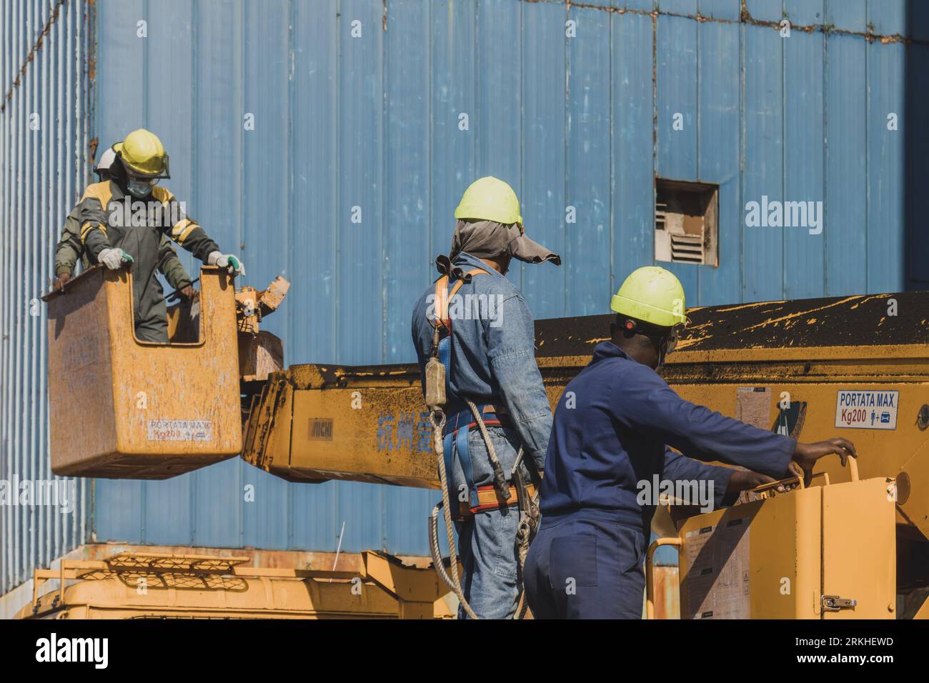 A rear view of two male workers working on a construction site Stock ...