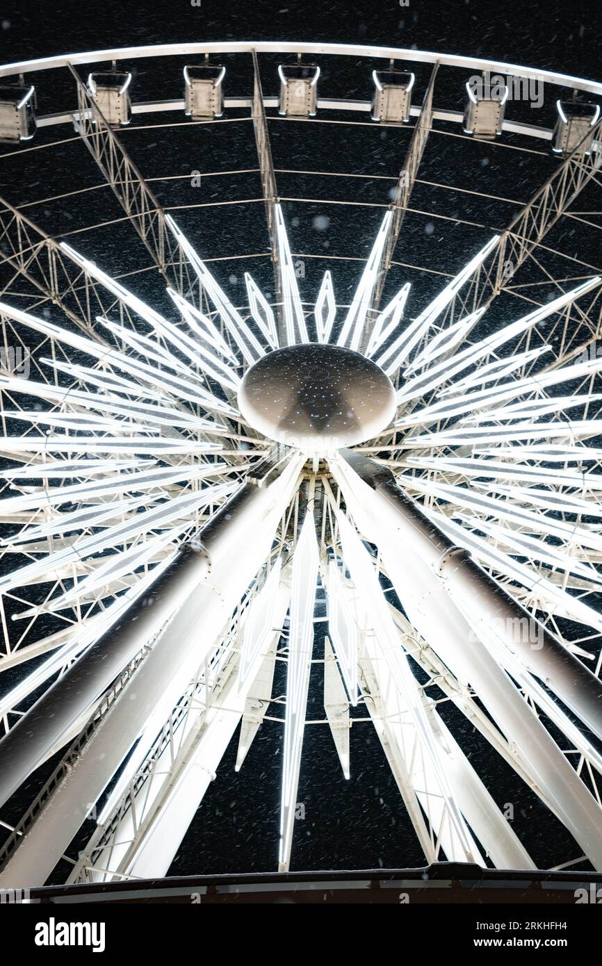 An illuminated ferris wheel stands in a wintery landscape Stock Photo ...