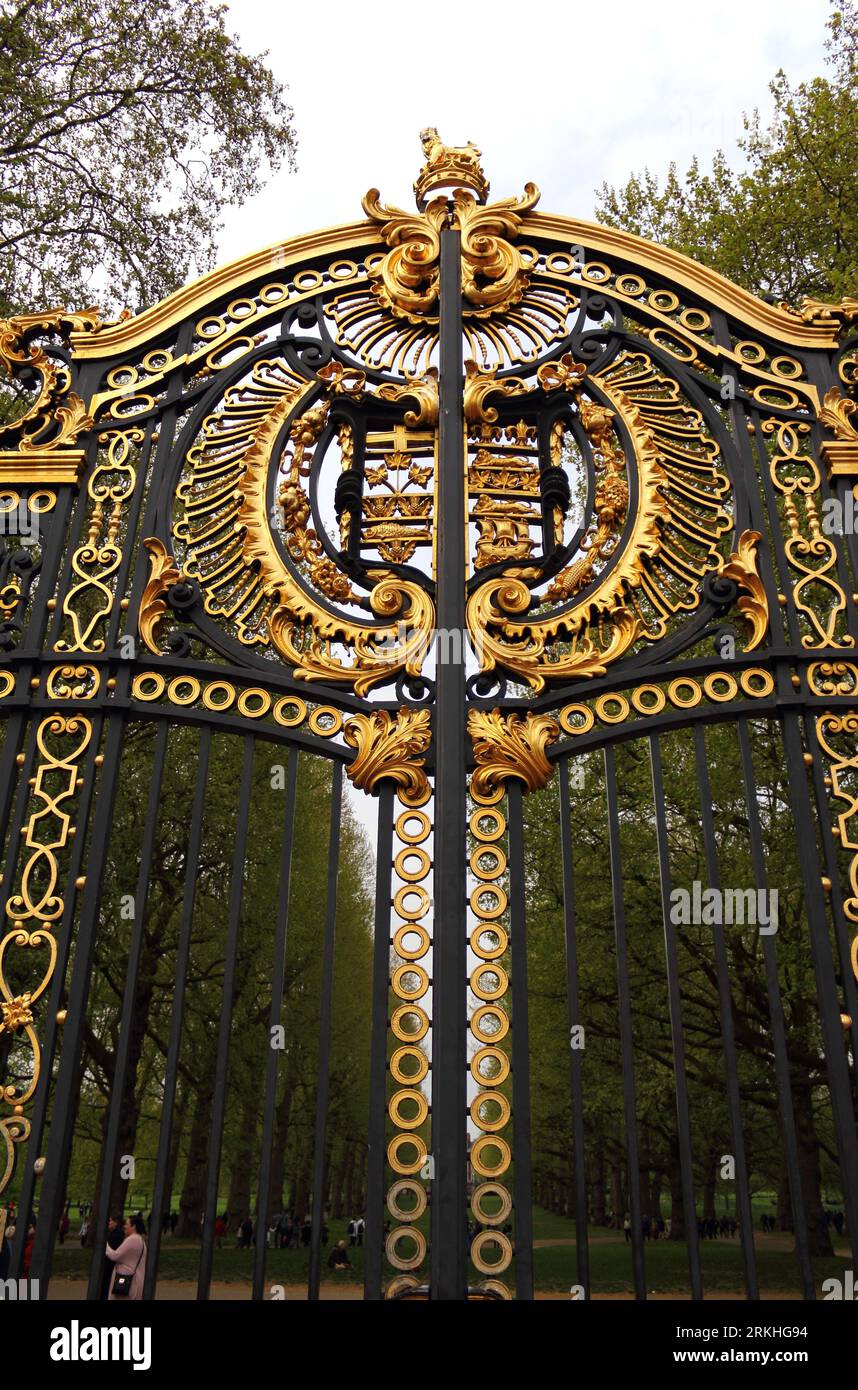 A beautiful golden-hued gate standing before a majestic brick wall in ...