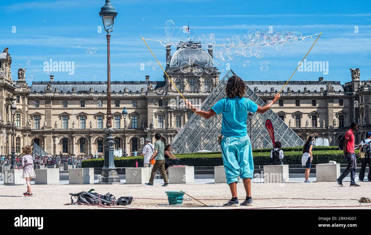 A street bubble artist performing an art piece in front of the iconic ...