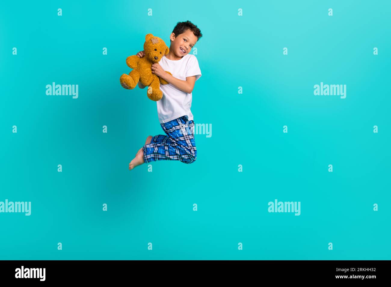 Full size photo of active excited small kid hold fluffy soft teddy bear ...