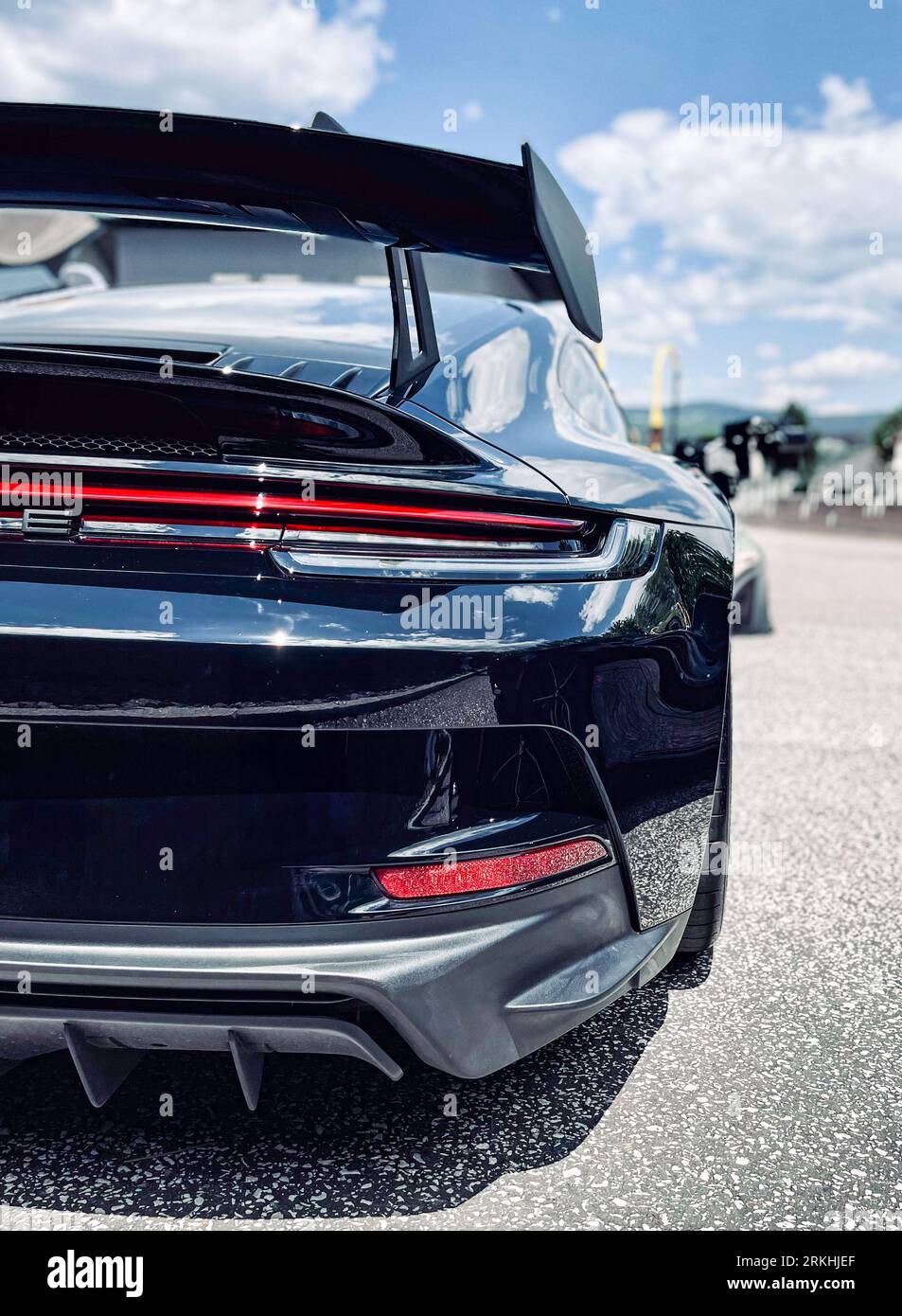 A close-up view of a Porsche sports car parked in a lot, showing the ...