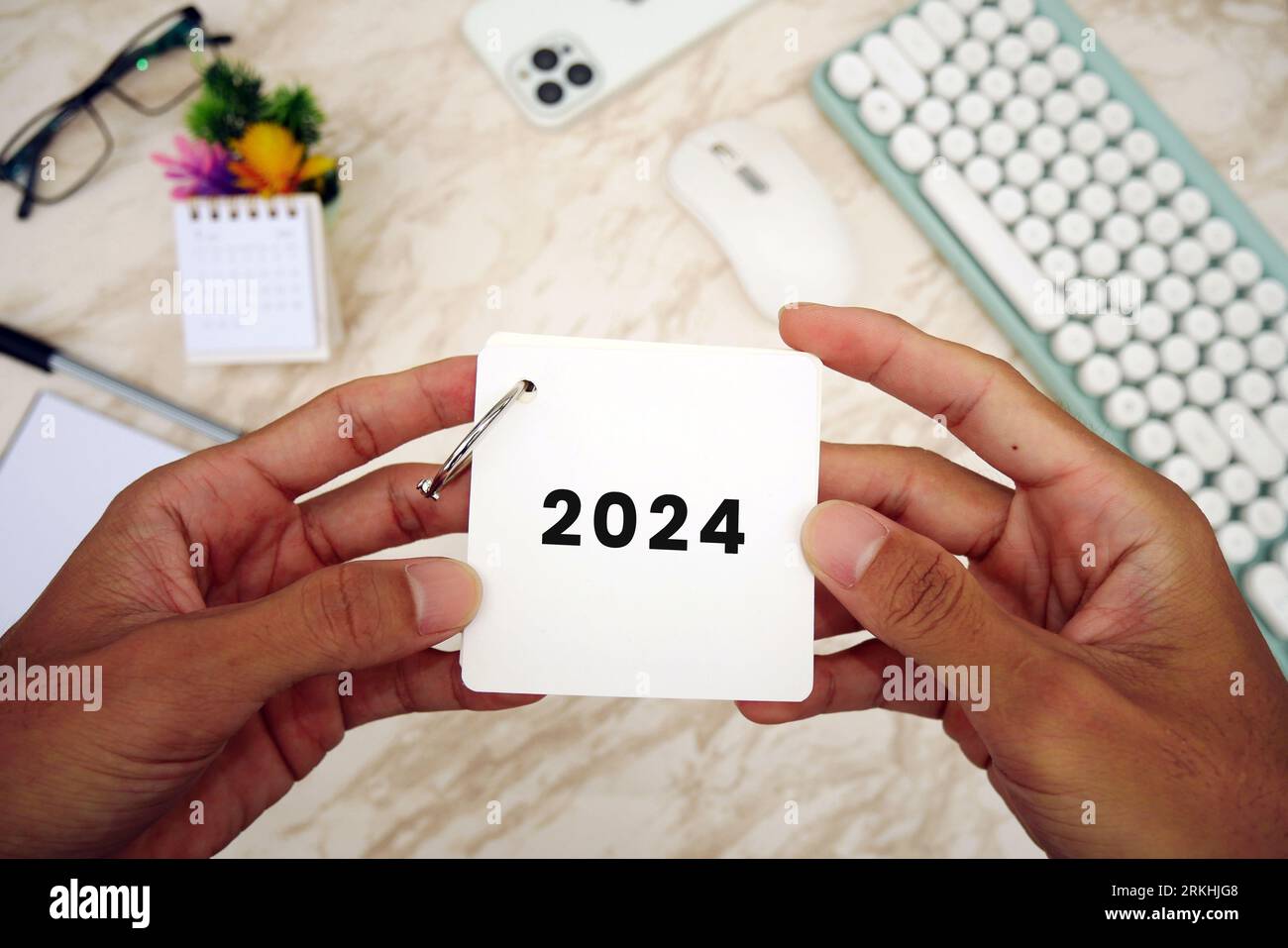 Male hand holding table calendar with white marble background. To-do ...