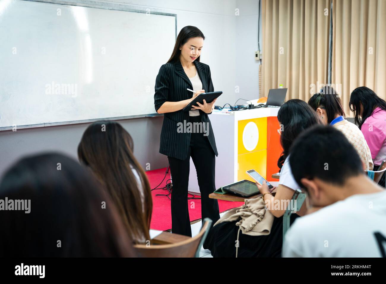 A Southeast Asian woman reading a lecture in a classroom Stock Photo ...
