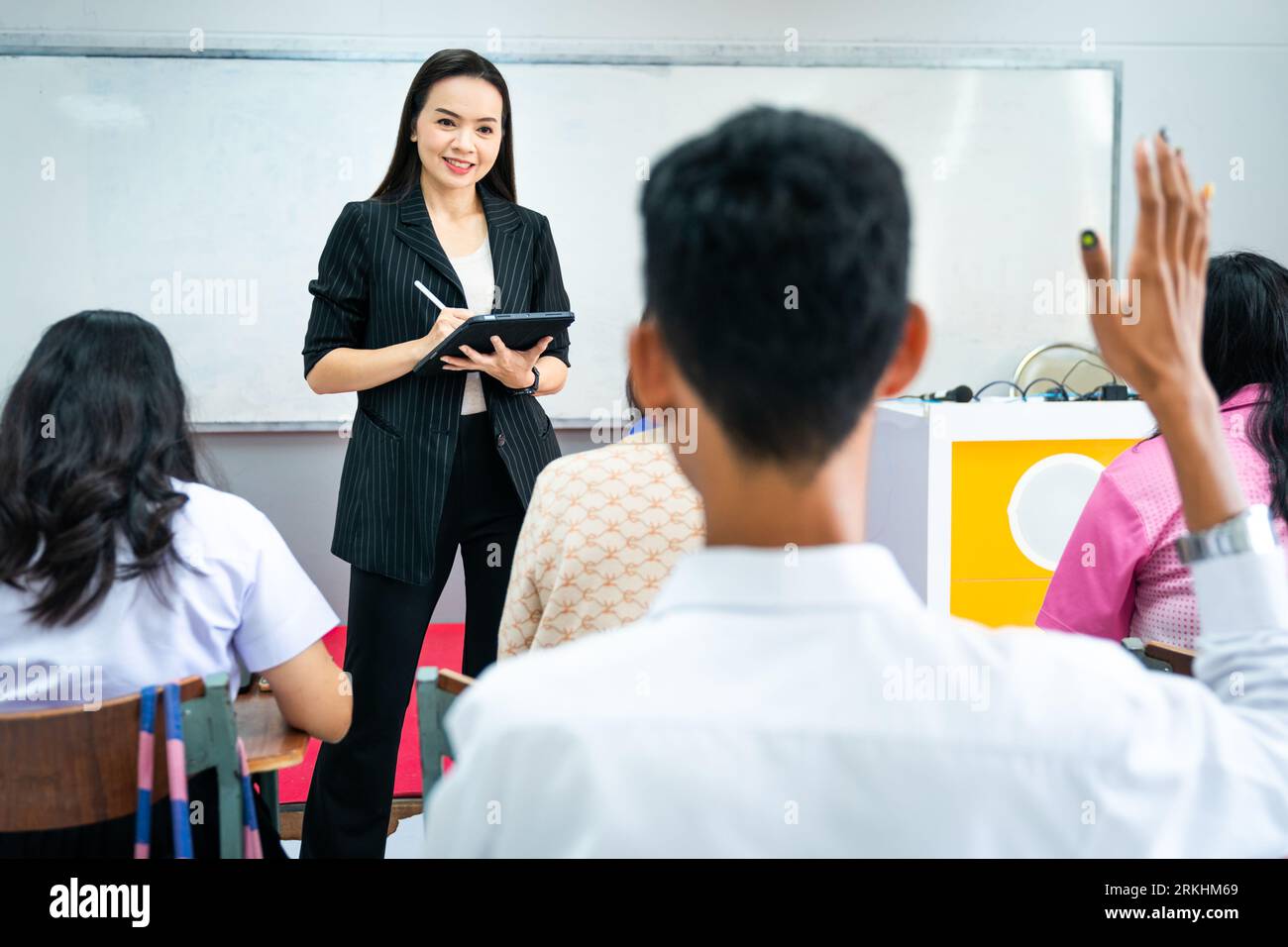 A Southeast Asian woman reading a lecture in a classroom Stock Photo ...