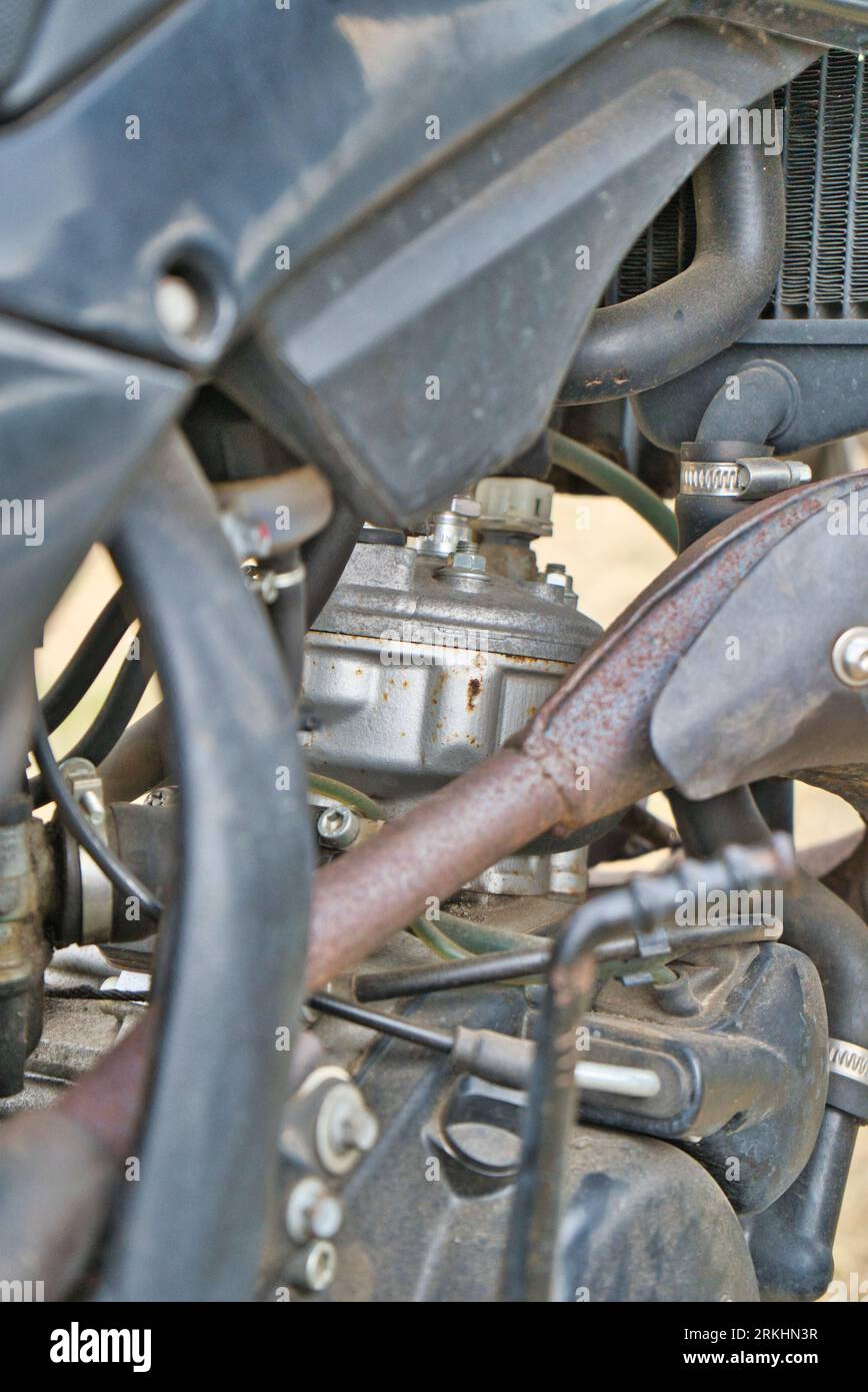 A vintage motorcycle with a smaller engine, parked outside in a grassy ...
