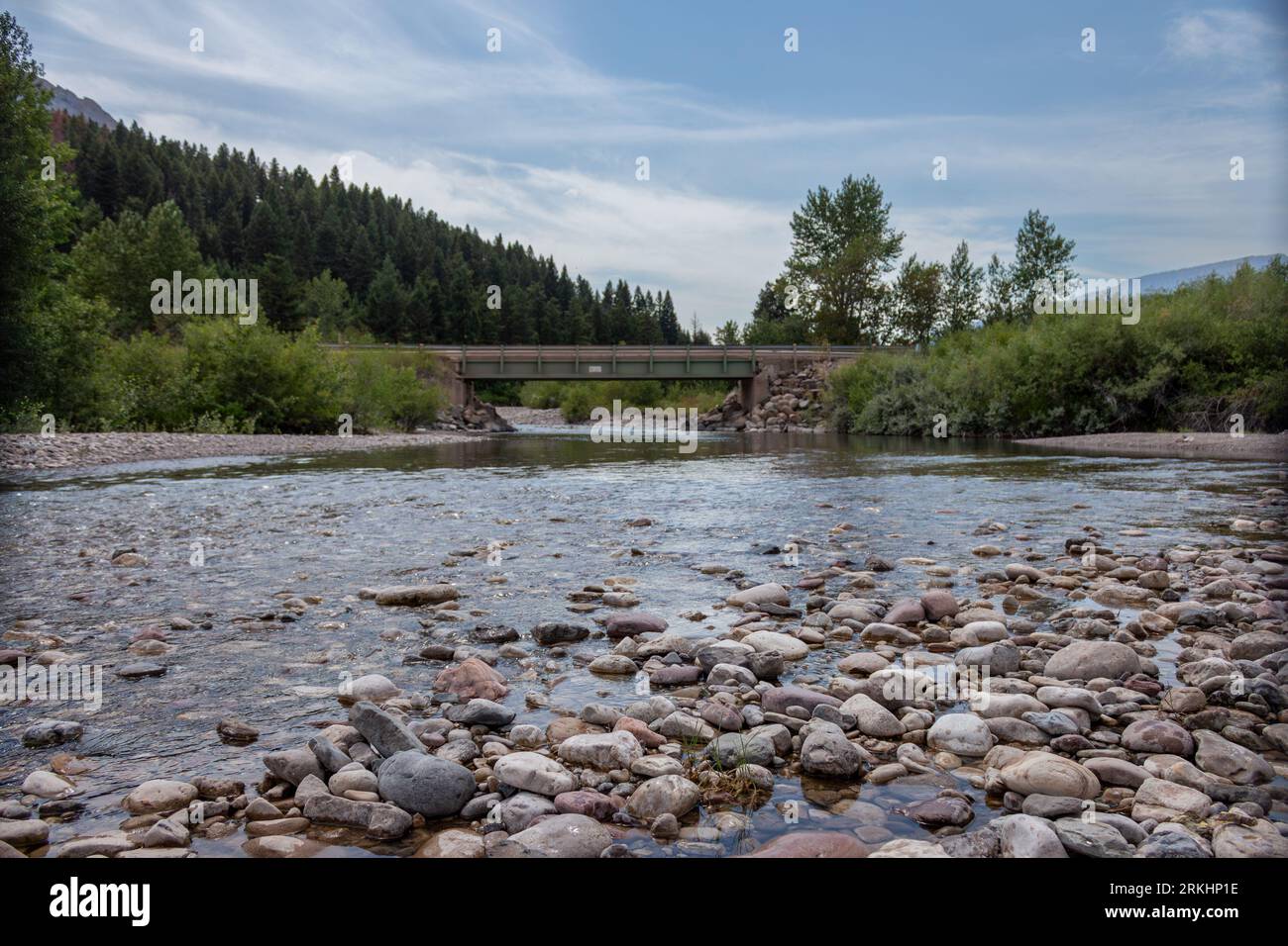 An aerial view of a bridge connecting two sides of a tranquil river ...