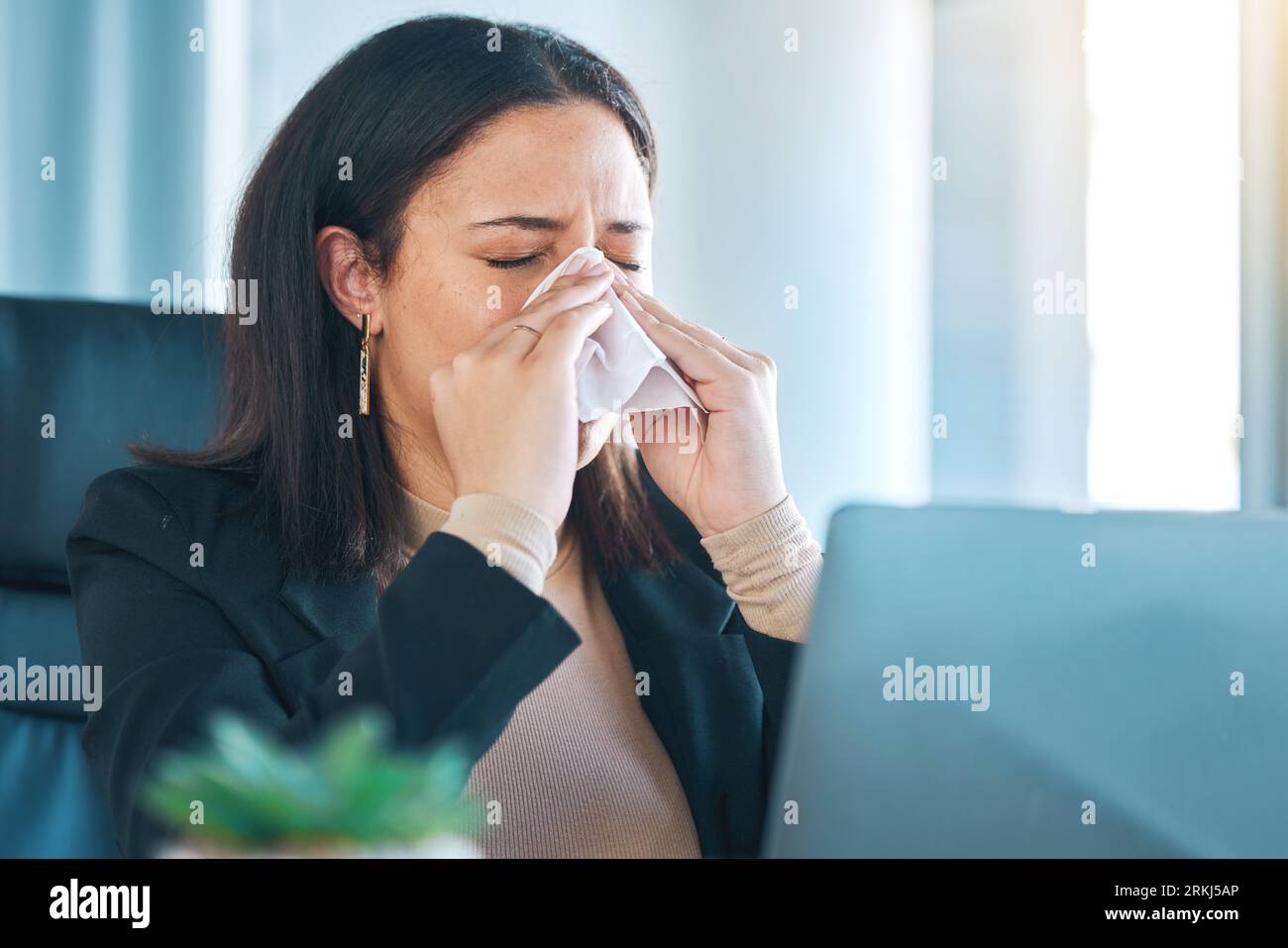 Tissue, sneeze and blowing nose with a business woman in her office for ...