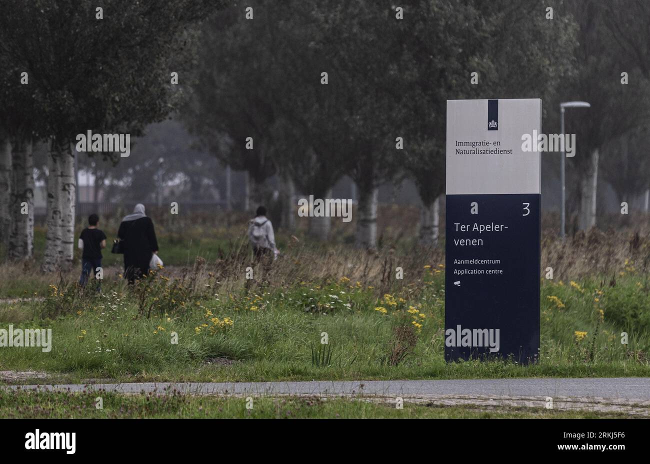 TER APEL - Refugees walk past the grounds of the COA reception center ...