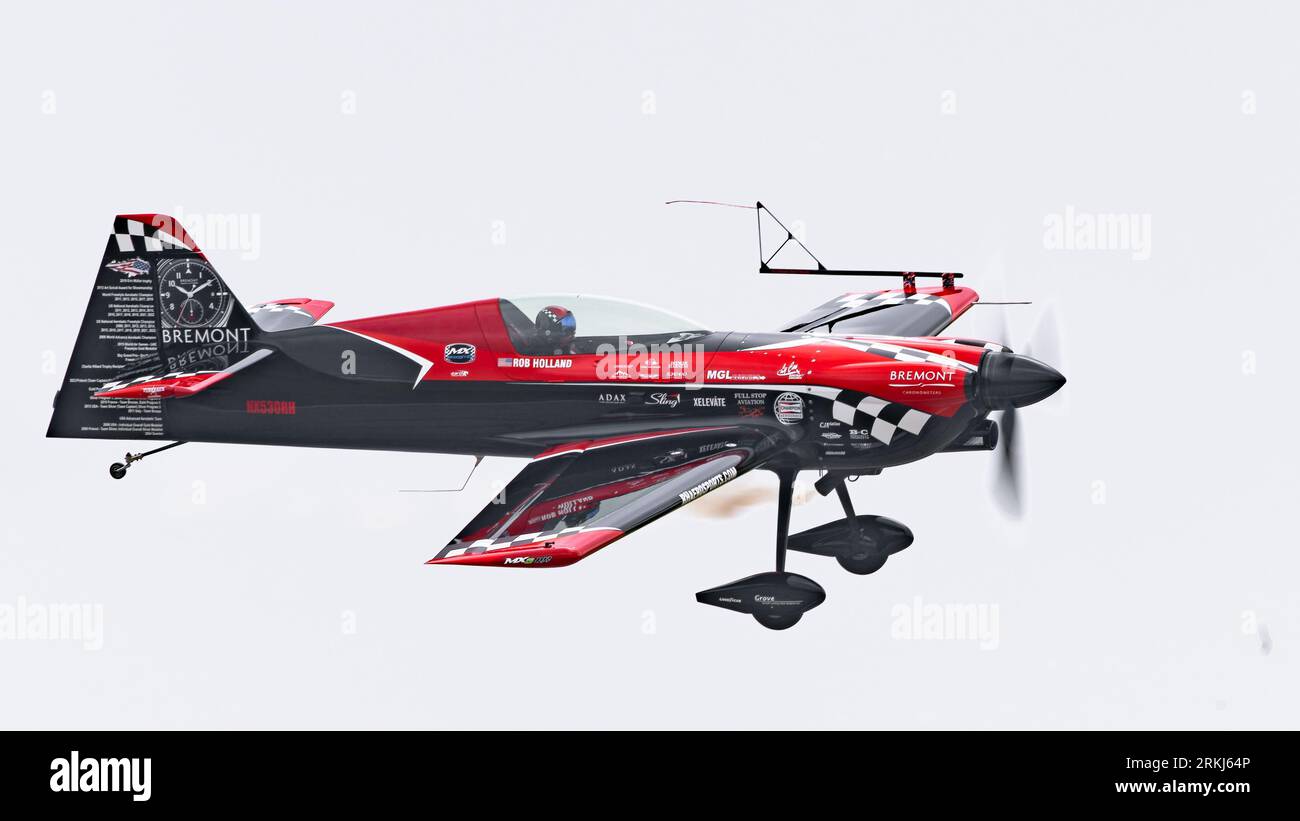 A small aircraft is pictured in mid-air, its wheels descended and ...