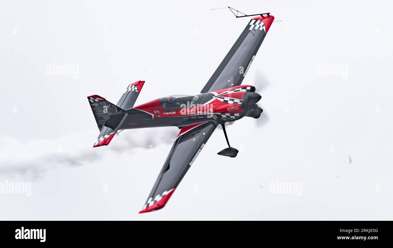 An aerial view of a single small aircraft performing daring aerobatic ...