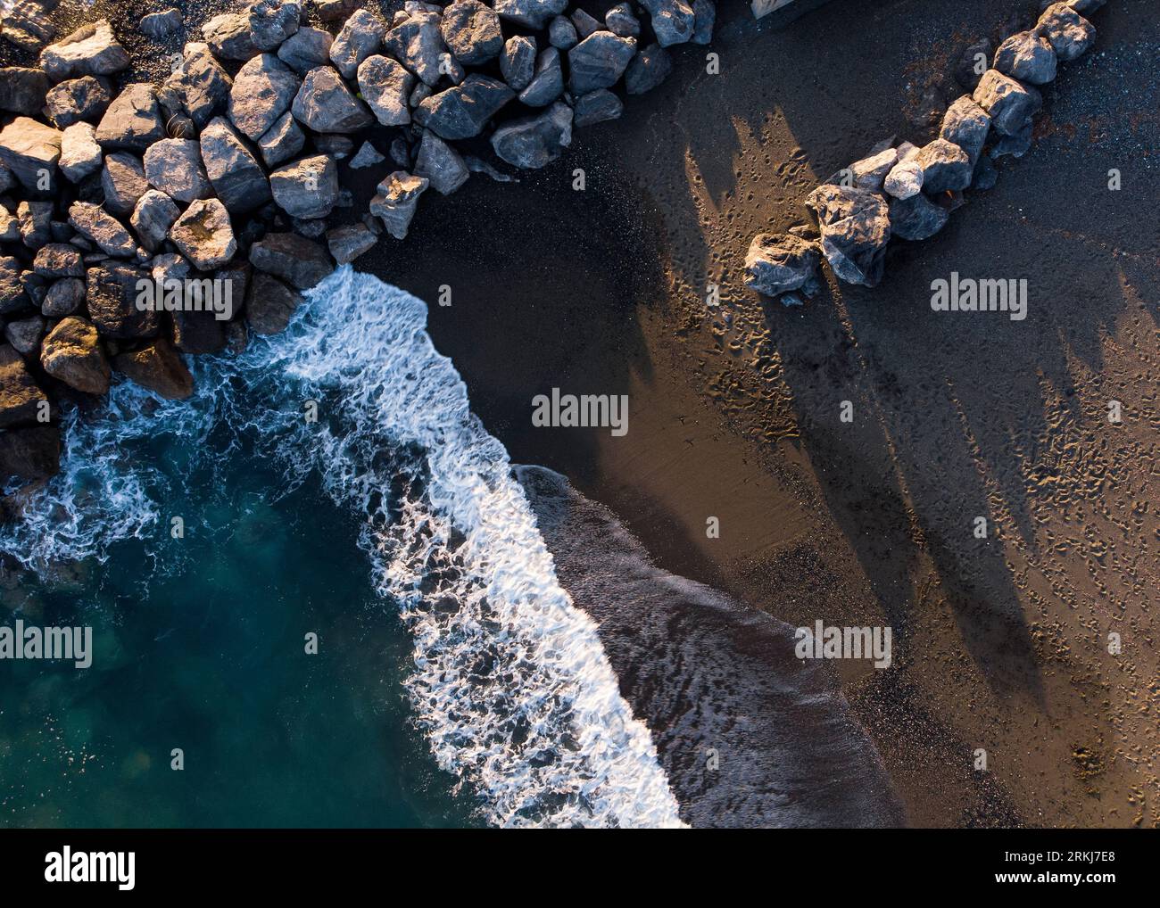 A beach with crystal-clear, rocky waters surrounding it: Cogoleto's ...