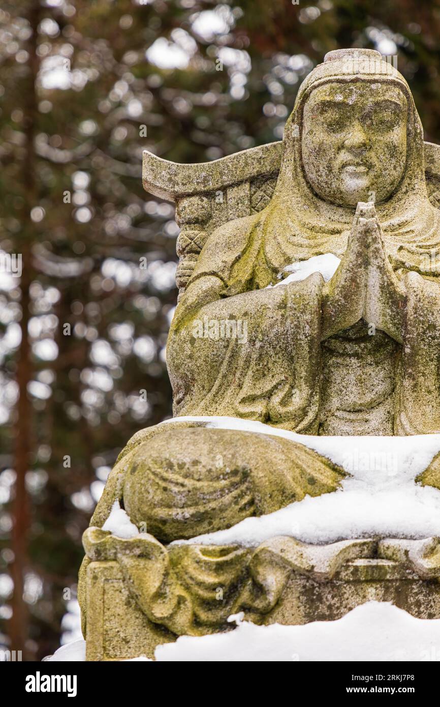 A statue covered in snow at Enryaku-ji Temple on Mount Hiei, Kyoto ...