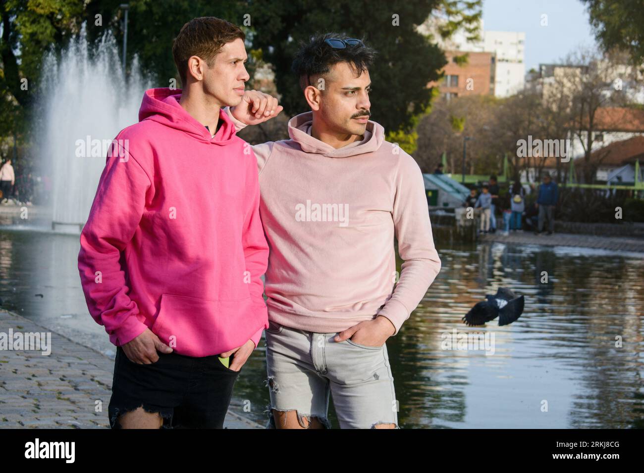 lgbt community male couple in pink sweater, together standing in public ...