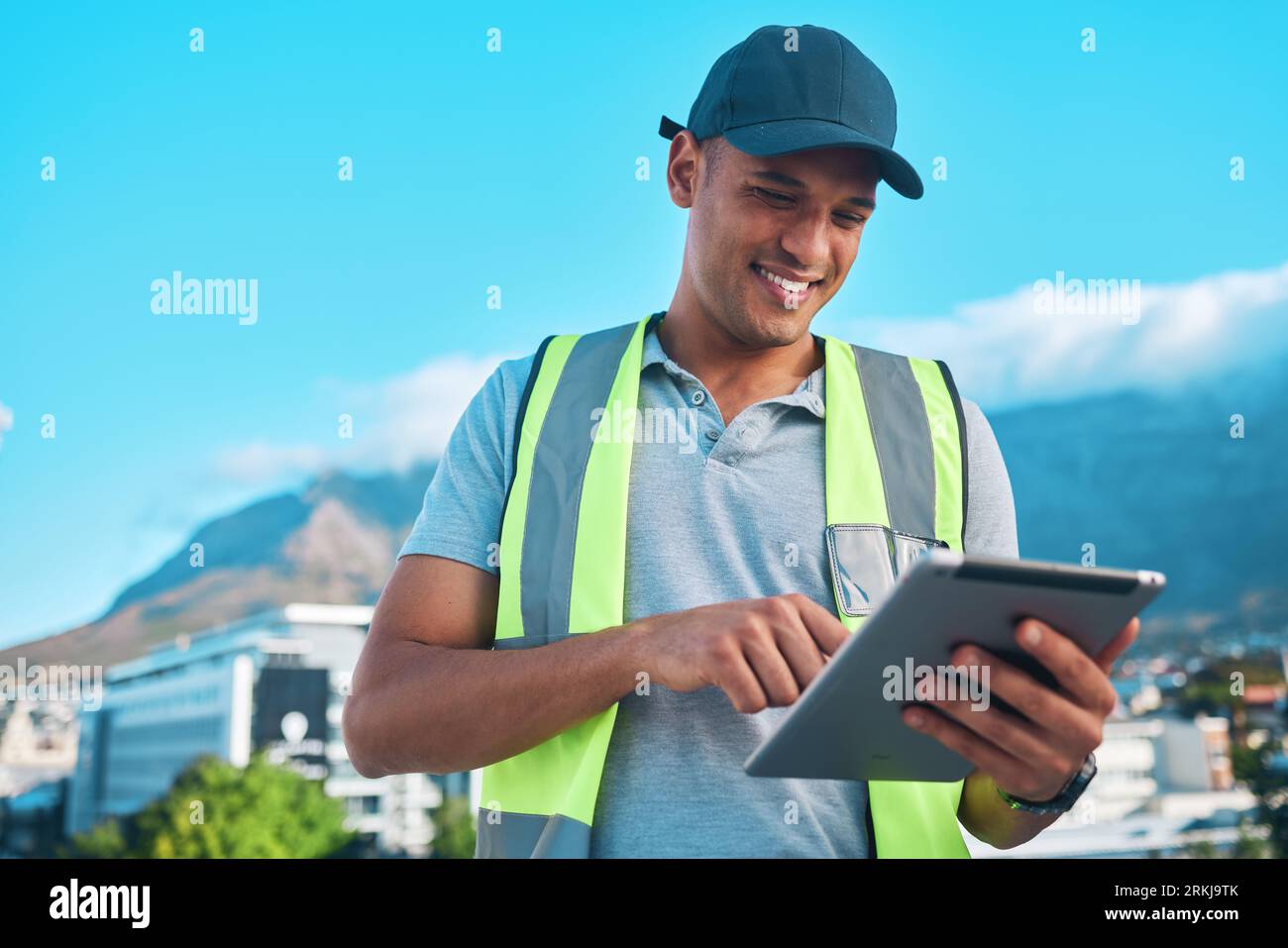 City, tablet and typing contractor, happy man and reading online floor ...