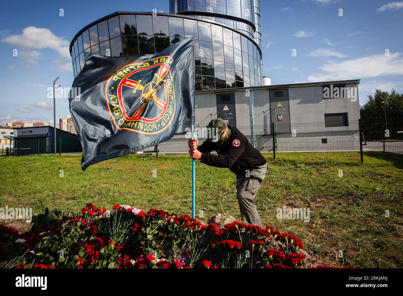 A member of the Wagner group sets up a flag with the symbol of the PMC ...