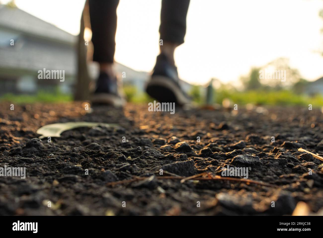 A man's feet perspective from the road in the early morning, focusing ...