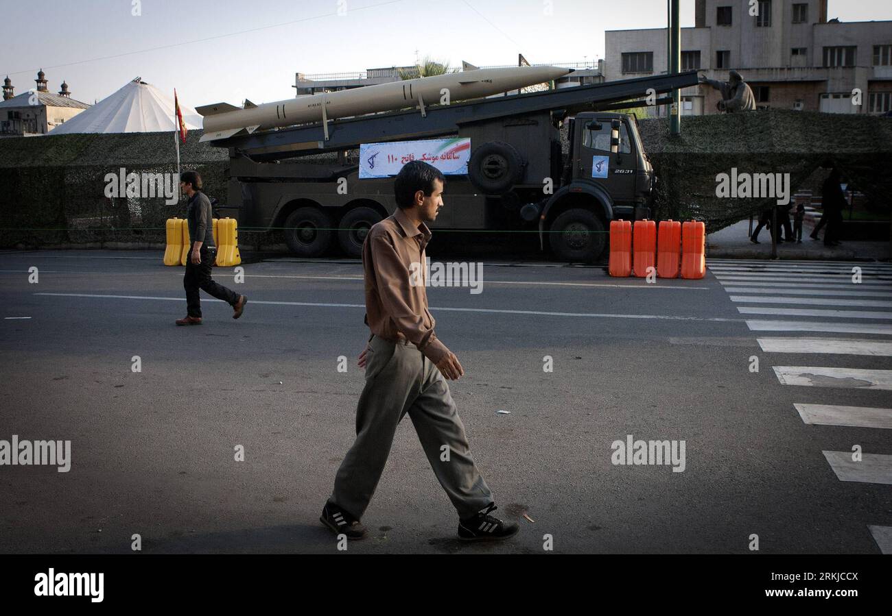110924-- TEHRAN, Sept. 24, 2011 Xinhua -- A man walks past an Iranian ...
