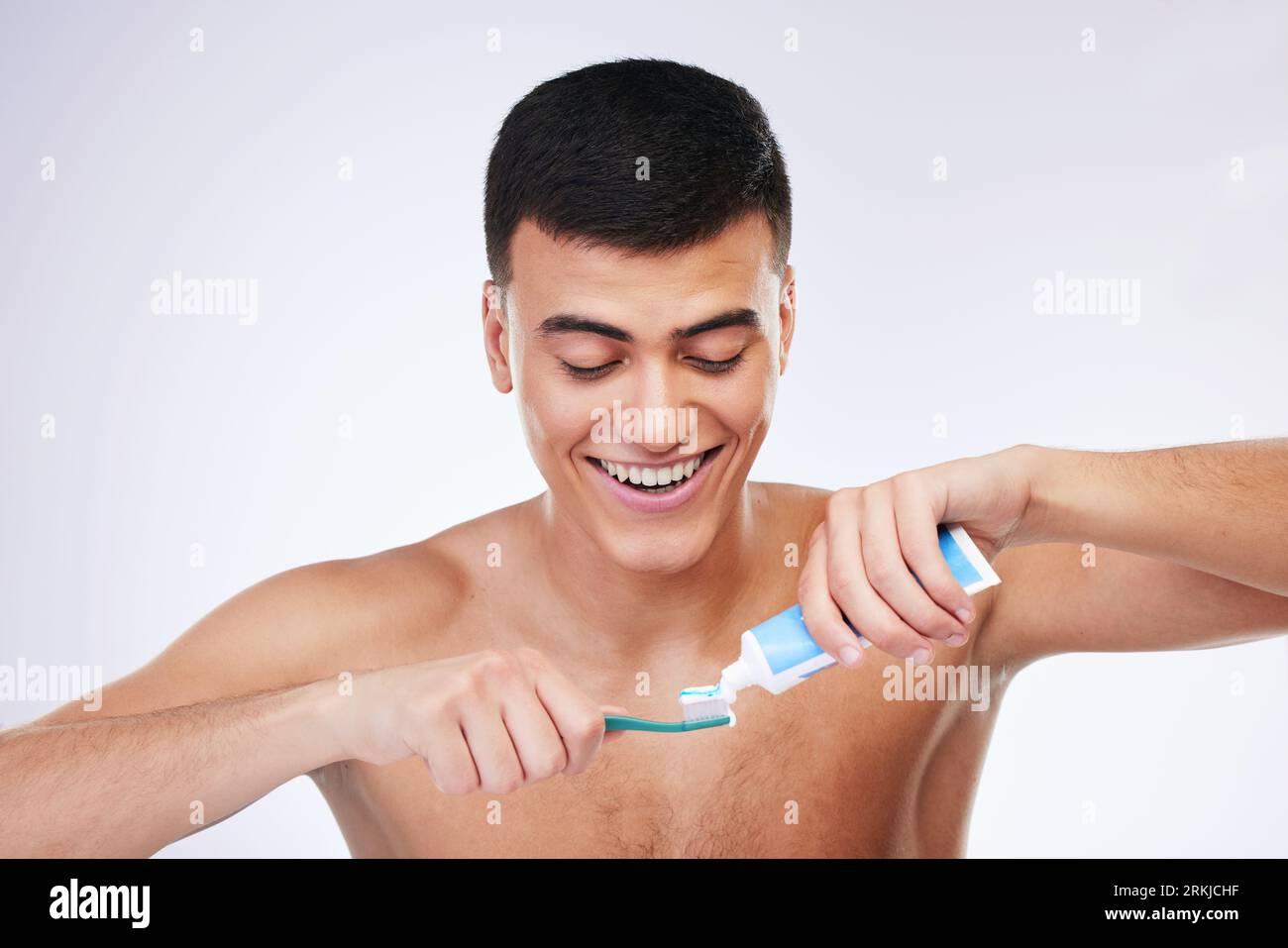 Happy man, toothbrush and toothpaste for cleaning teeth in dental care hygiene or grooming ...
