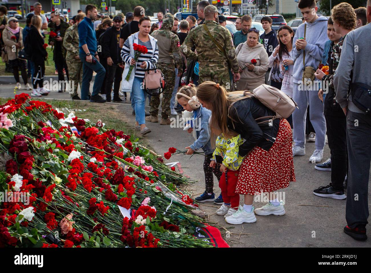 A woman and a kid lay flowers in memory of Yevgeny Prigozhin at a ...