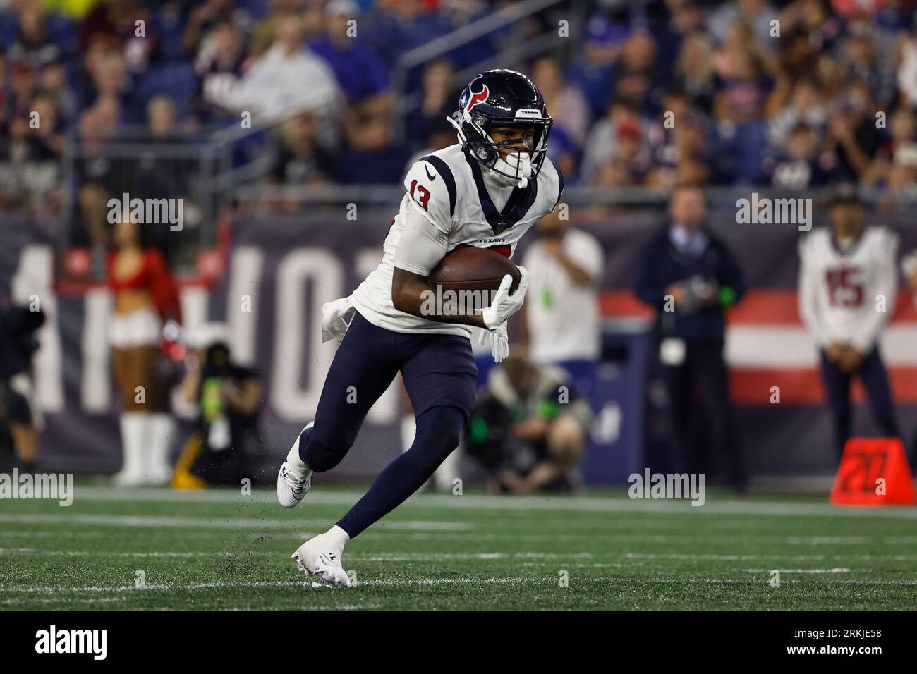Houston Texans wide receiver Tank Dell runs after a catch against the ...