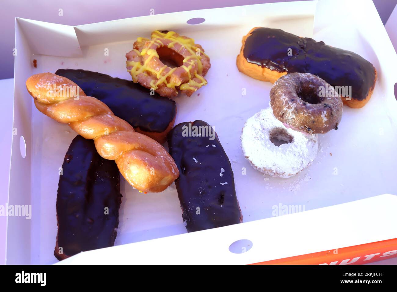 A close-up of donuts in a box during grand opening of the Fisker EV ...