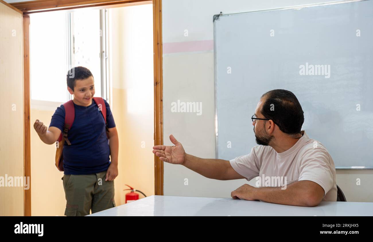 teacher explaining to his student separately and discussing some study ...