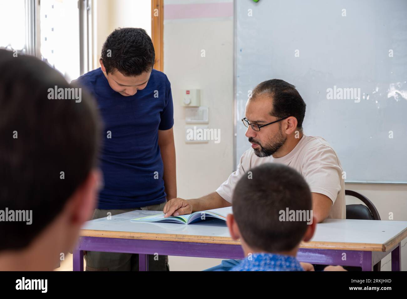 teacher explaining to his student separately and discussing some study ...