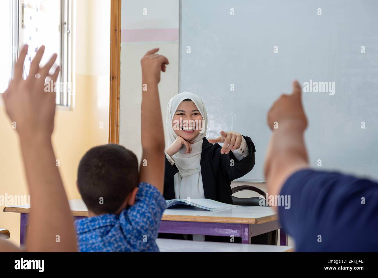 Arab school children hand raised hi-res stock photography and images ...