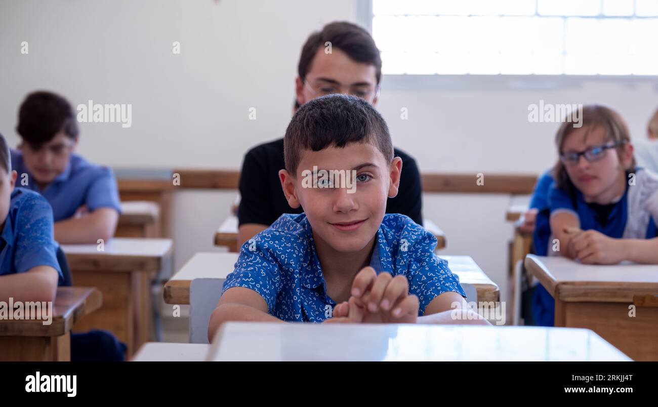 Boy studying in school with his colleagues Stock Photo - Alamy